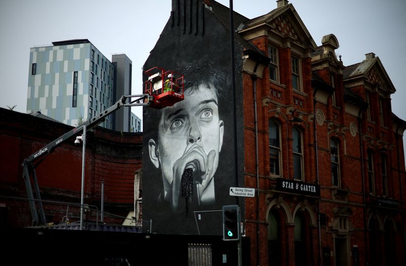 Artist Akse P19 works on a mural of singer Ian – One America News Network