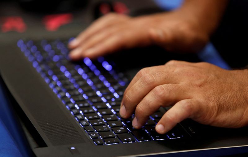 FILE PHOTO: A man types into a keyboard during the – One America News ...